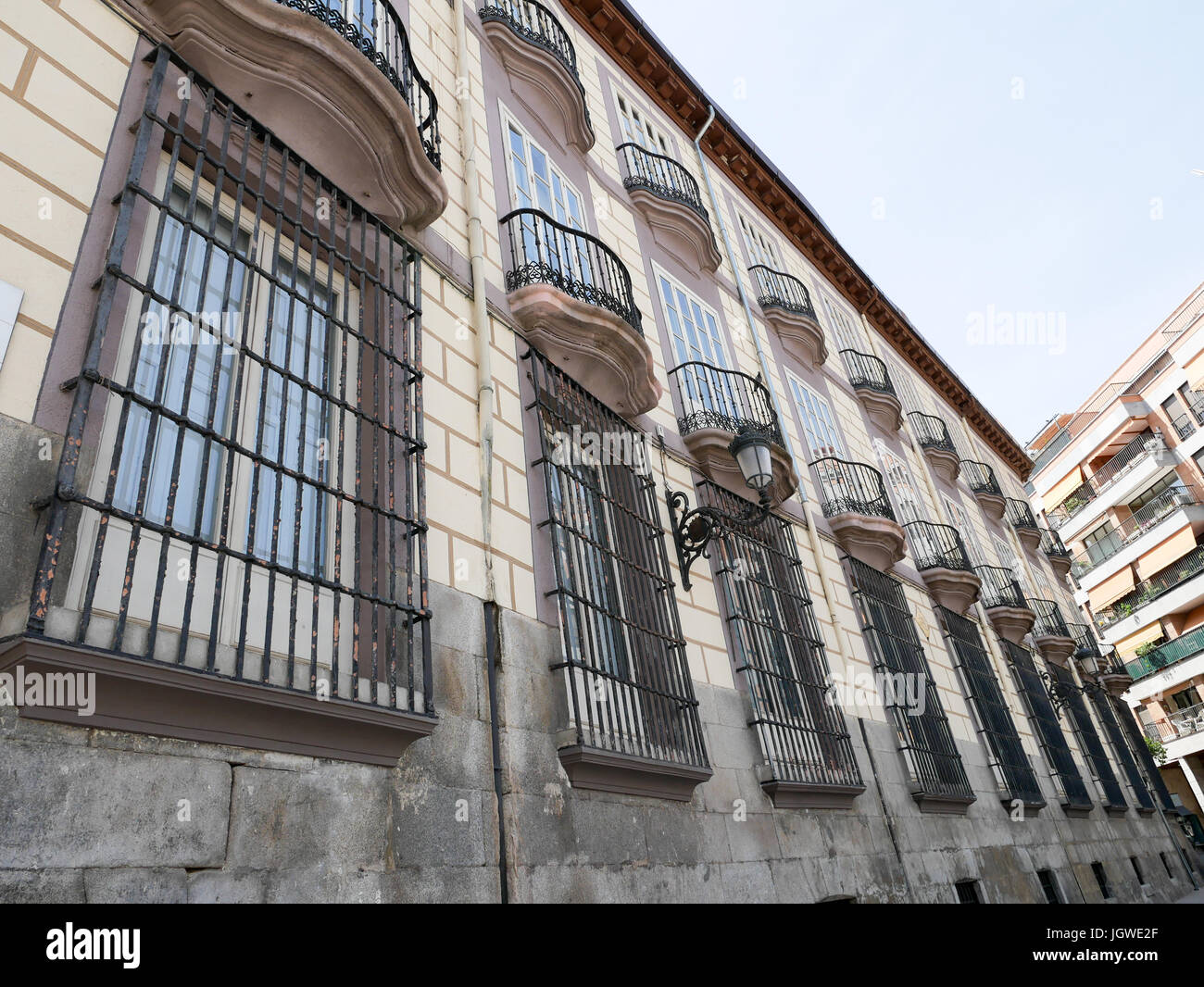 Low angle view of building windows with fence and balcony Stock Photo ...