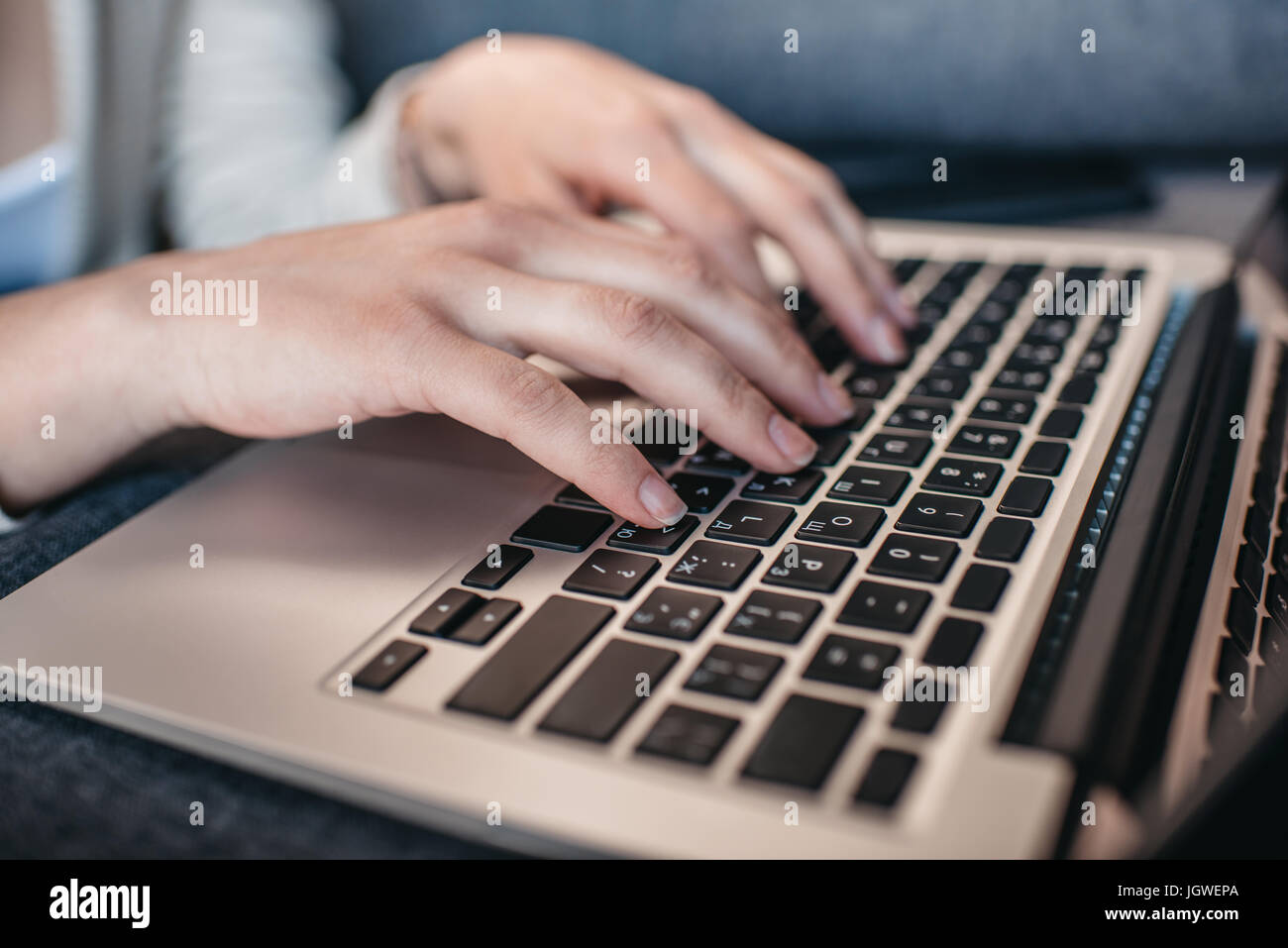 Cropped shot of human hands typing on keyboard of laptop Stock Photo ...
