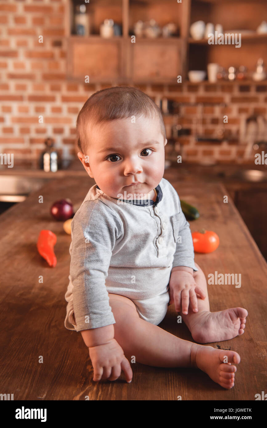 Boy sitting at kitchen table hi-res stock photography and images - Alamy