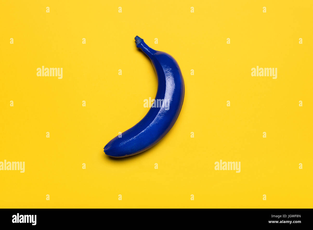 Top view of blue colored banana isolated on yellow, colorful background ...