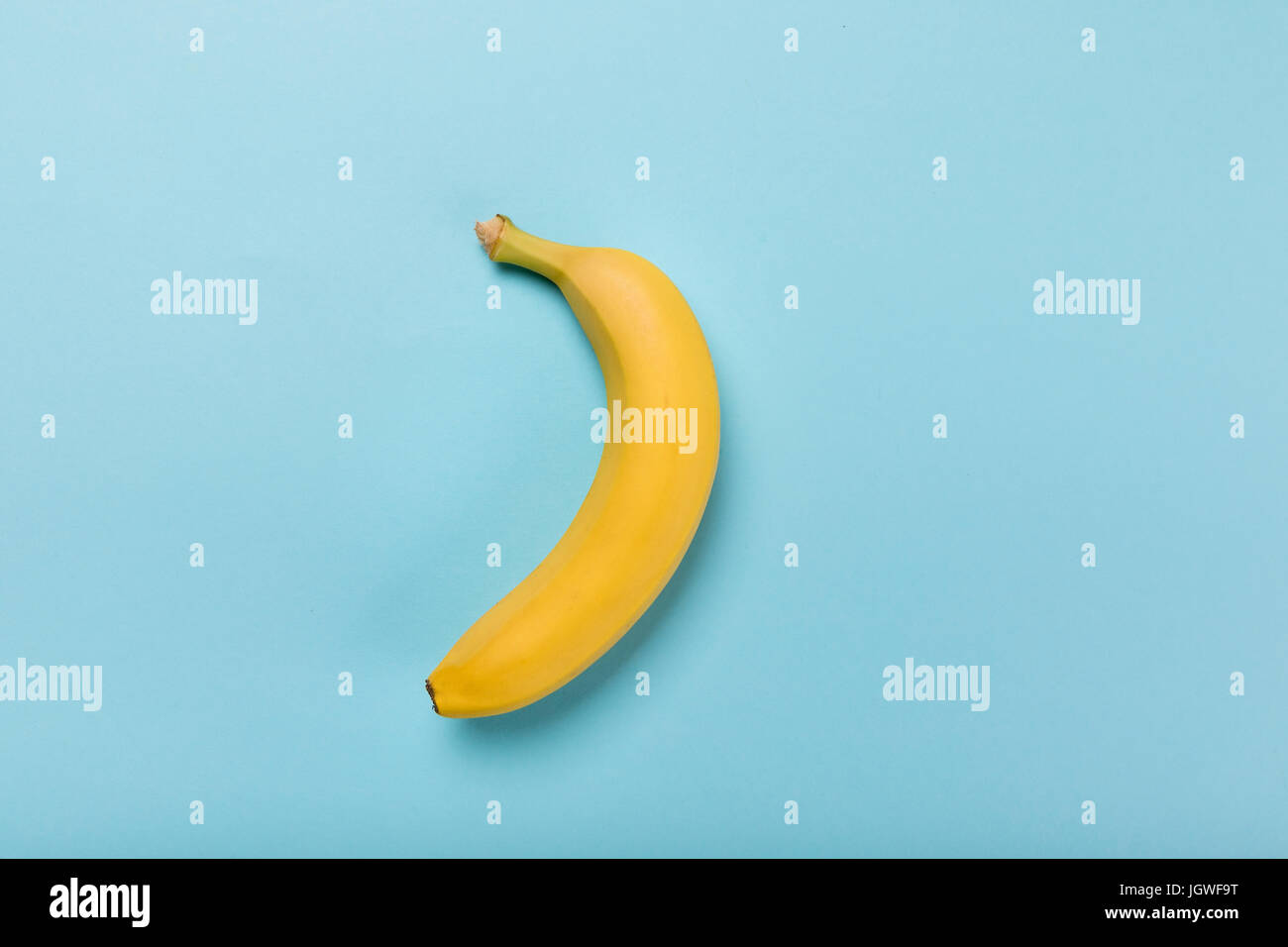 Top view of fresh yellow banana isolated on blue, colorful background ...