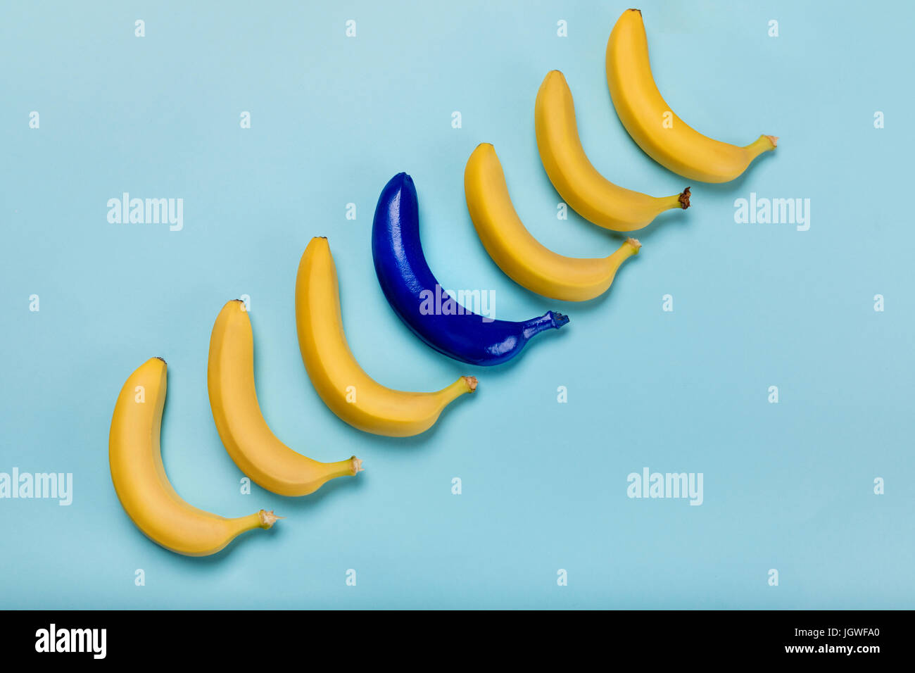 Top view of yellow and blue bananas isolated on blue, ripe bananas ...