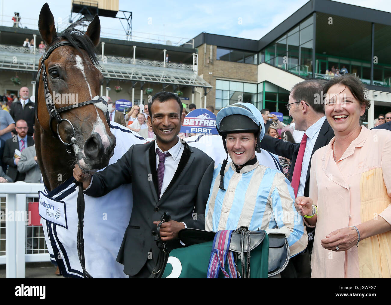 Jockey Tom Queally and Groom Nadeem celebrate after winning the Stobart ...