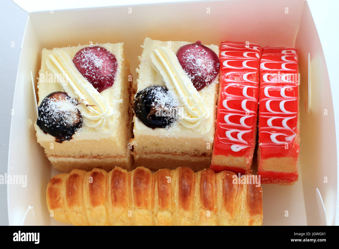 A box of mixed varieties of cakes and desserts Stock Photo - Alamy