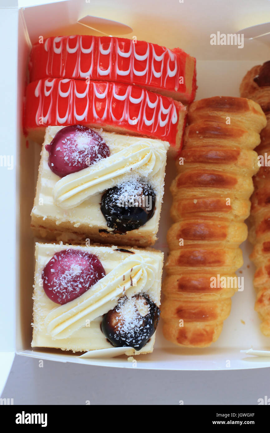 A box of mixed varieties of cakes and desserts Stock Photo - Alamy