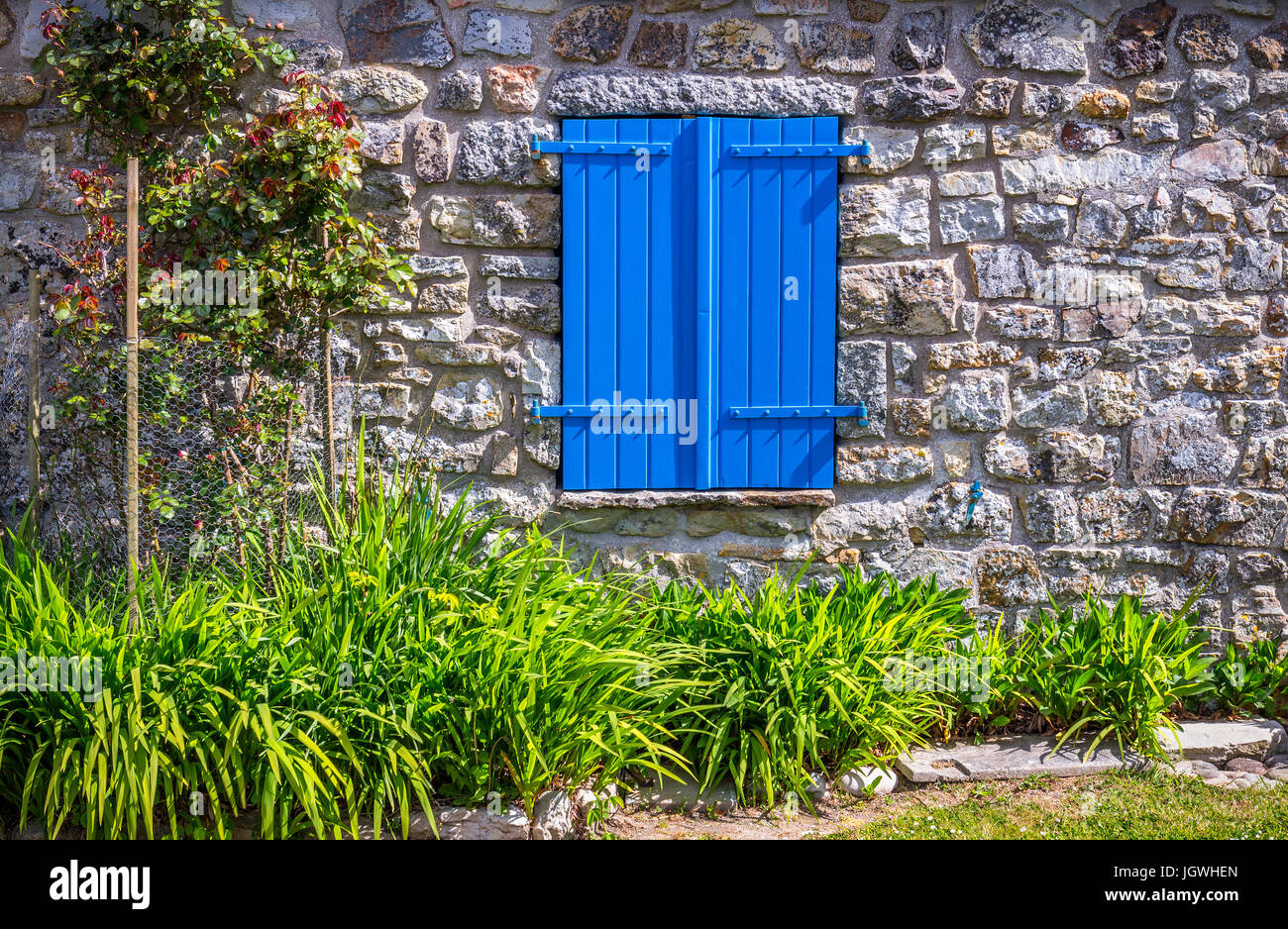Closed blue window blinds at stone house Stock Photo - Alamy