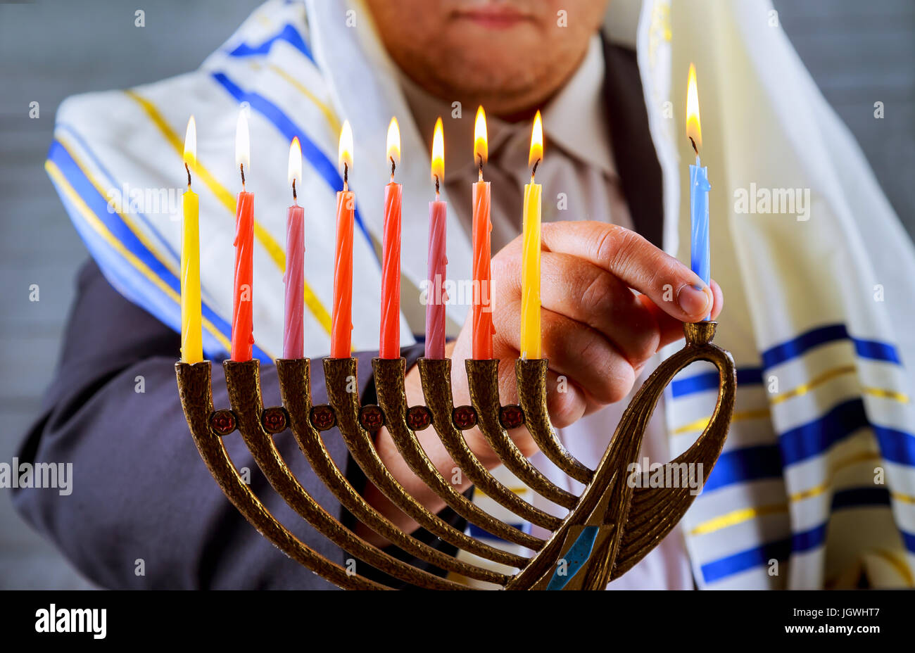 Hanukkah, a Jewish celebration. Candles burning in the menorah, the man ...