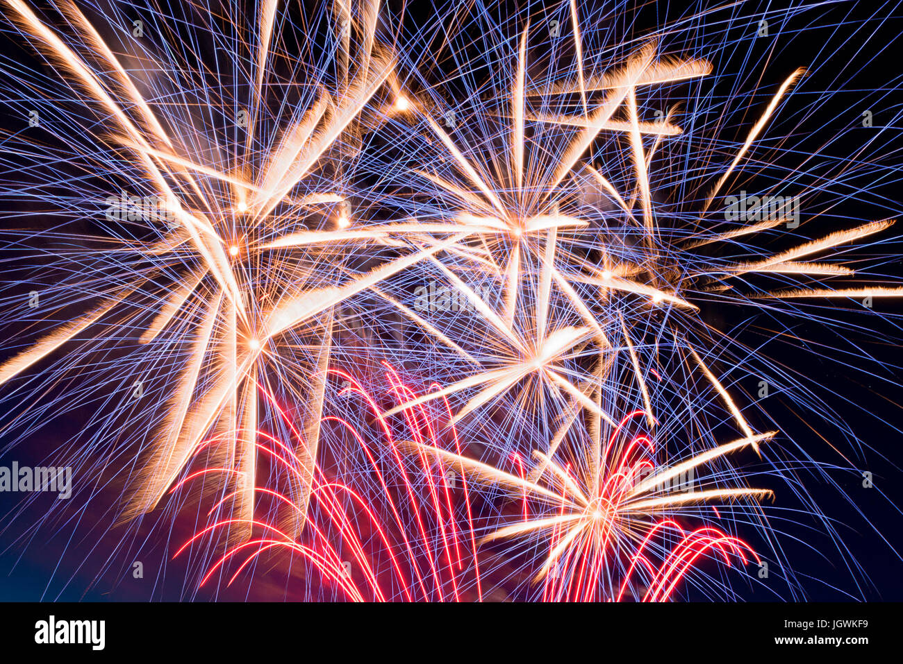 Details of fireworks, red, blue, orange, yellow and white with sky in ...
