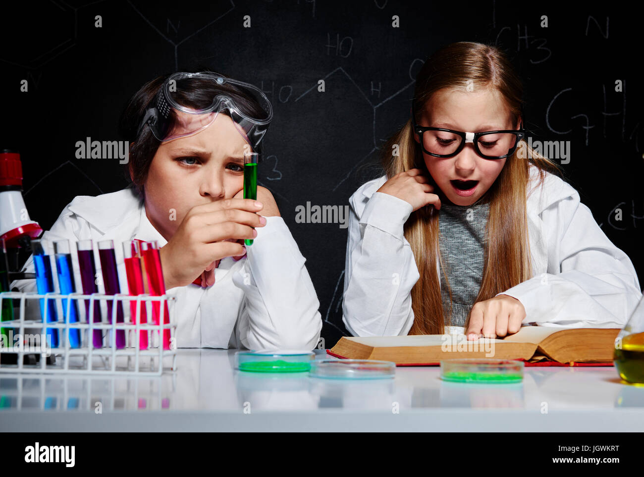Kids are focus on hard experiment Stock Photo - Alamy