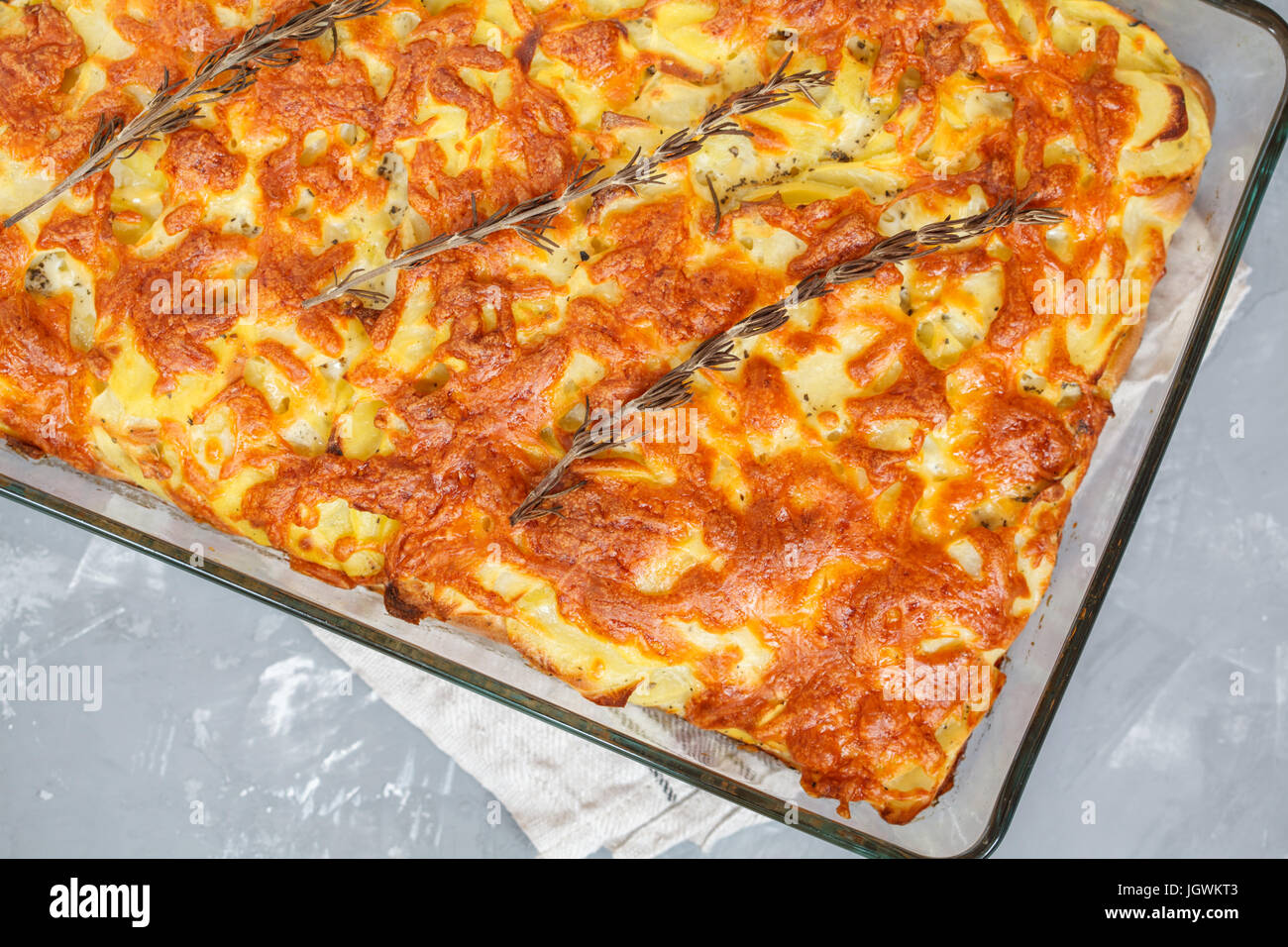 Potato pie with cheese baked in glass form Stock Photo - Alamy