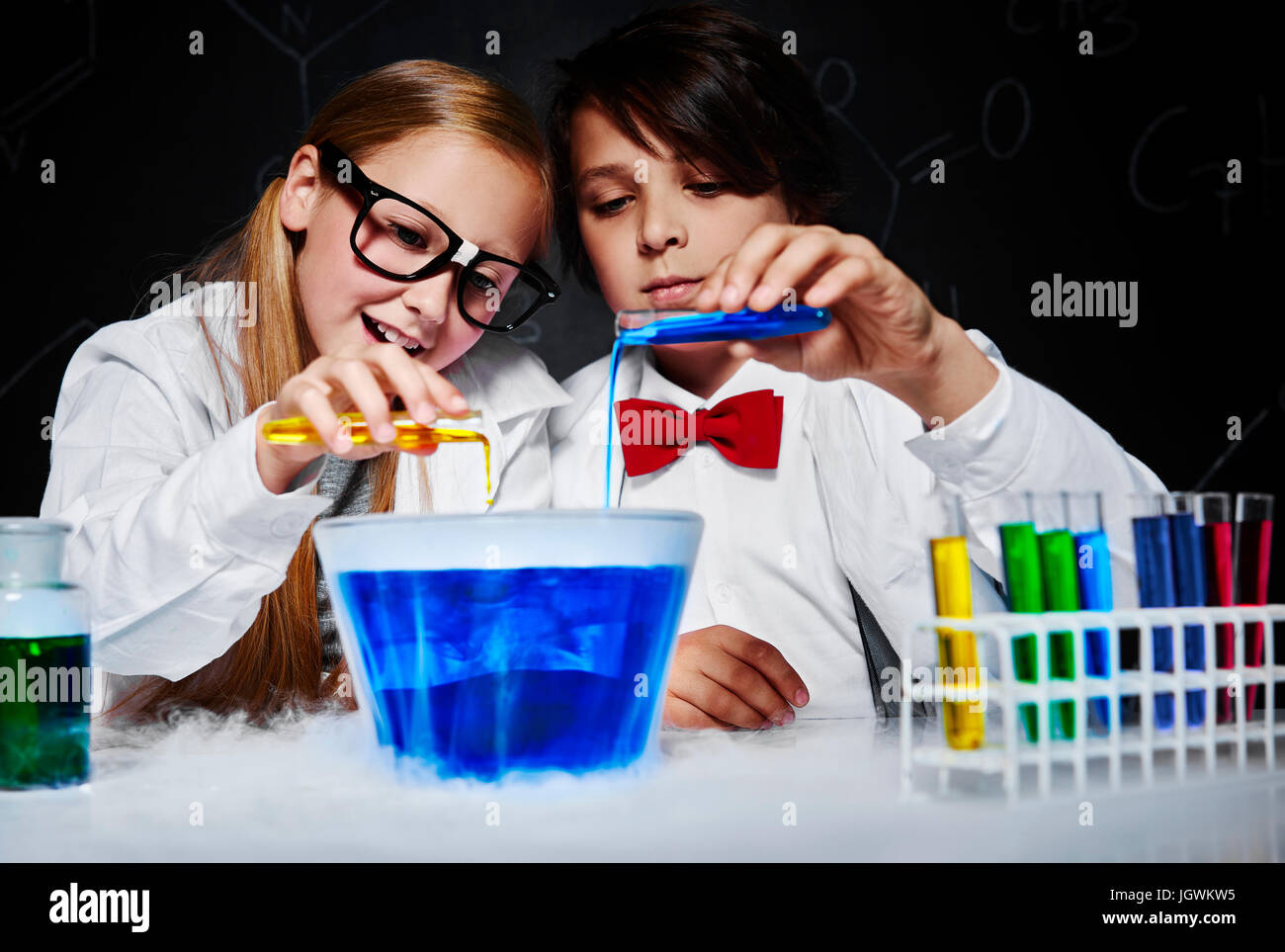 Kids making a serious experiment Stock Photo - Alamy