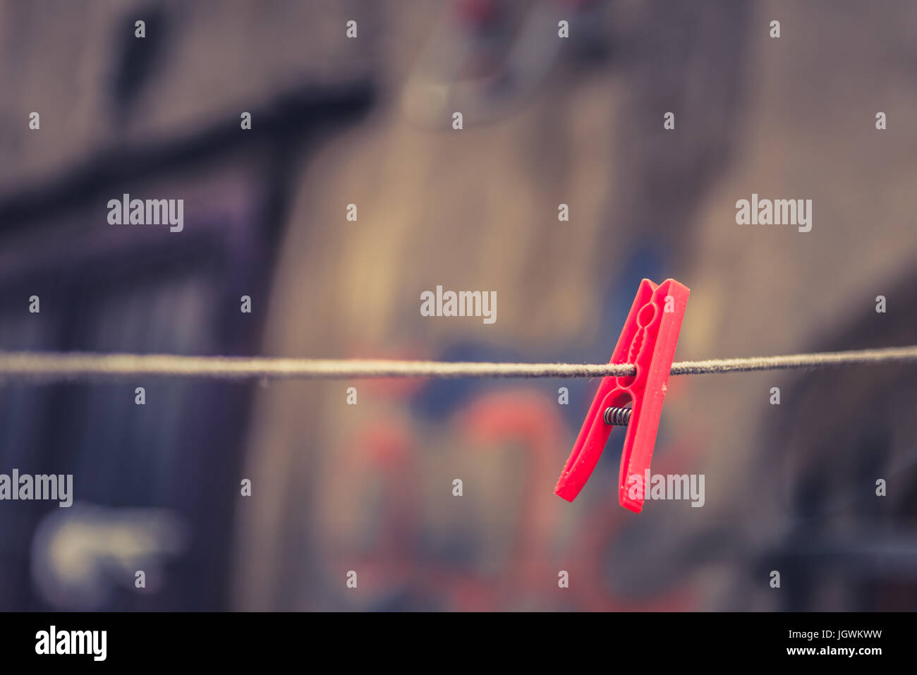 Vintage view of Clothes peg pinned to a bench with dark wall in a ...