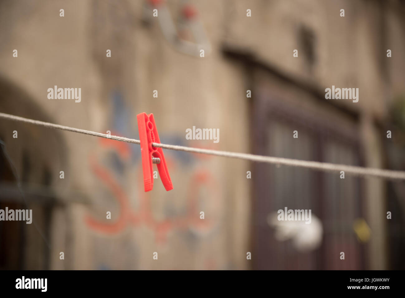 Vintage view of Clothes peg pinned to a bench with dark wall in a ...
