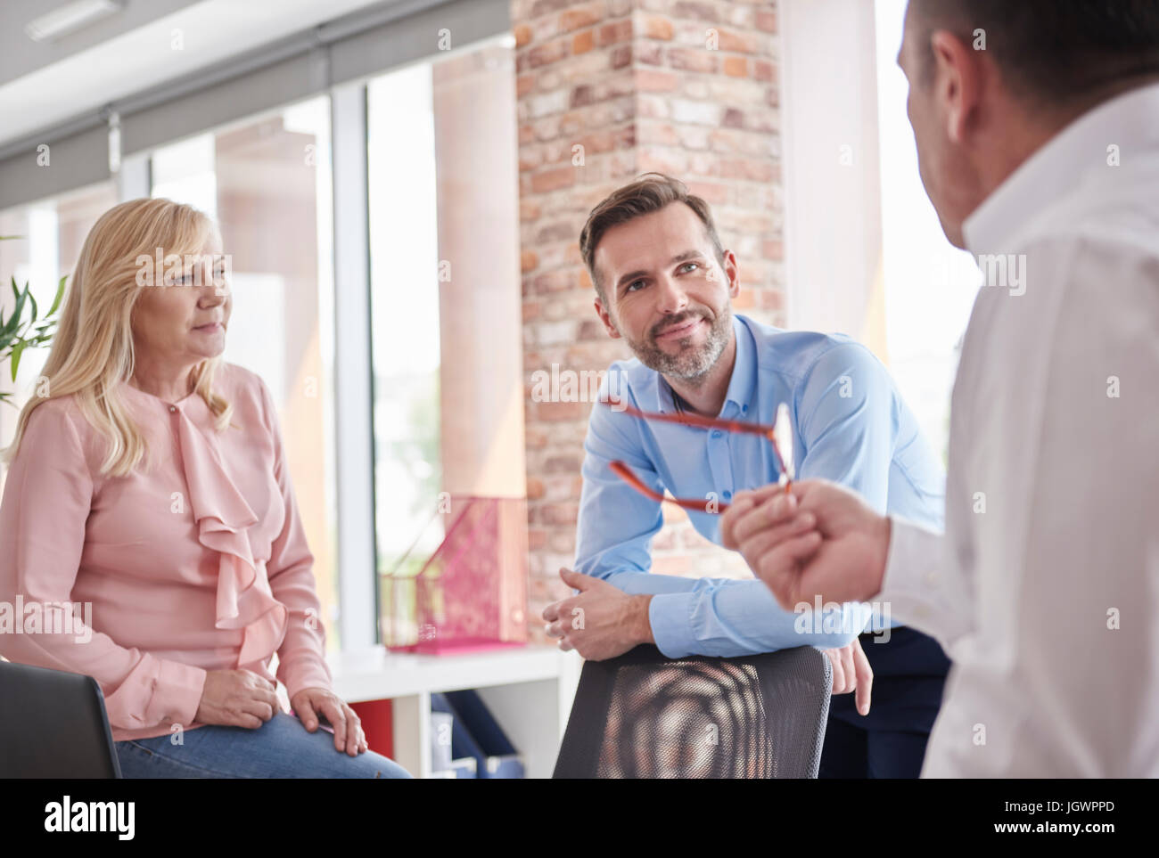 Colleagues having discussion in office Stock Photo - Alamy