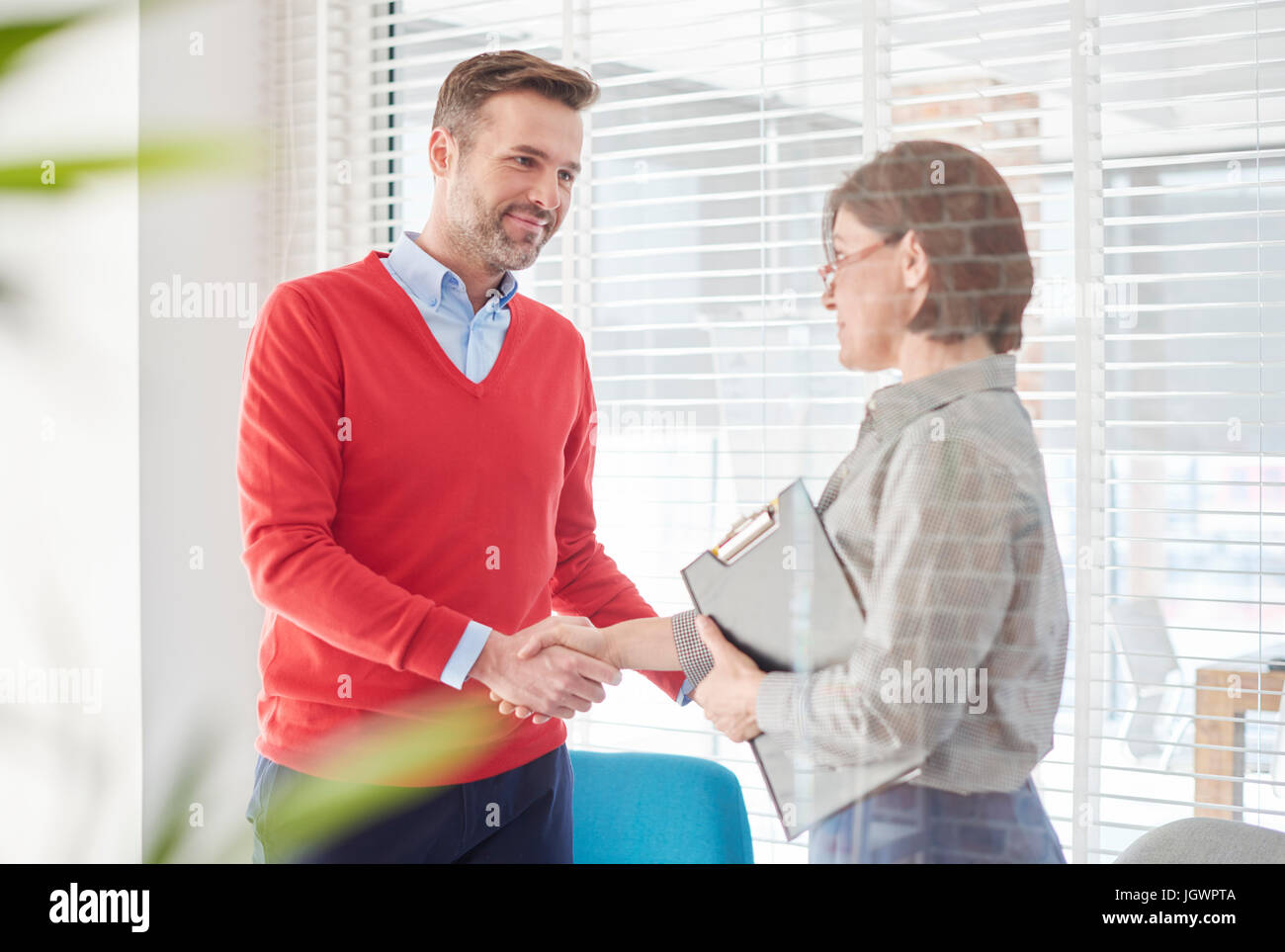 Man shaking hands at job interview Stock Photo - Alamy