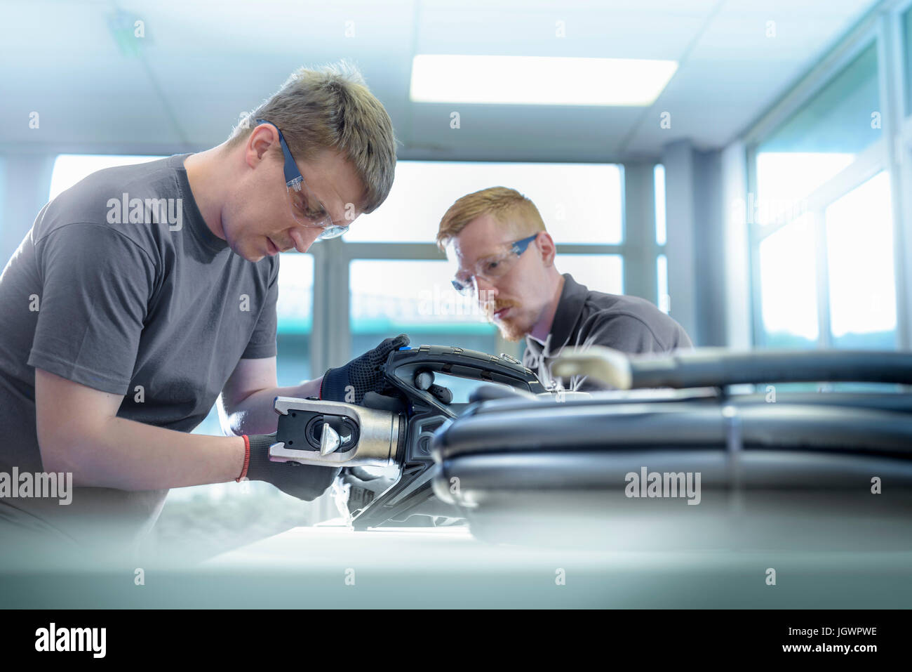 Apprentice electrical engineers in cable finishing factory Stock Photo ...