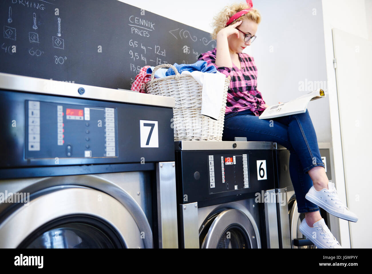 Girl sitting on washing machine hi-res stock photography and images - Alamy