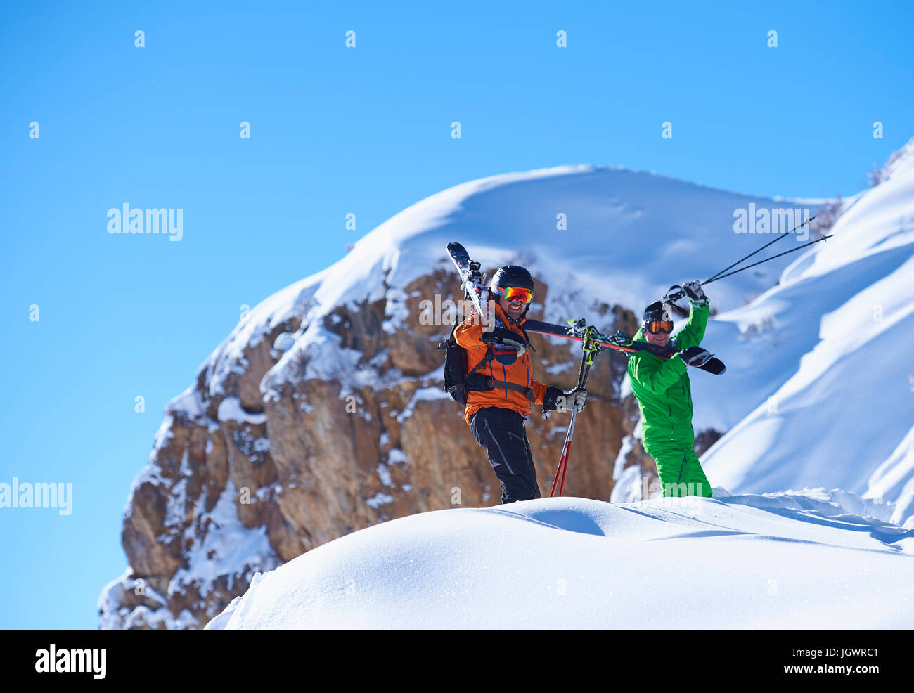 Two male skiers trudging up snow covered ridge, Aspen, Colorado, USA ...