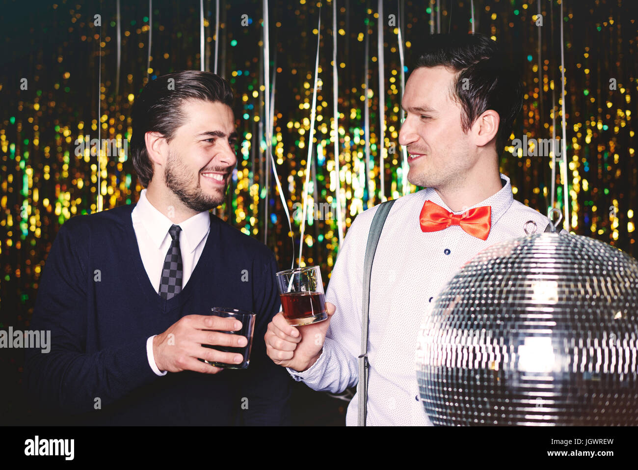 Two men at party, holding drinks Stock Photo - Alamy