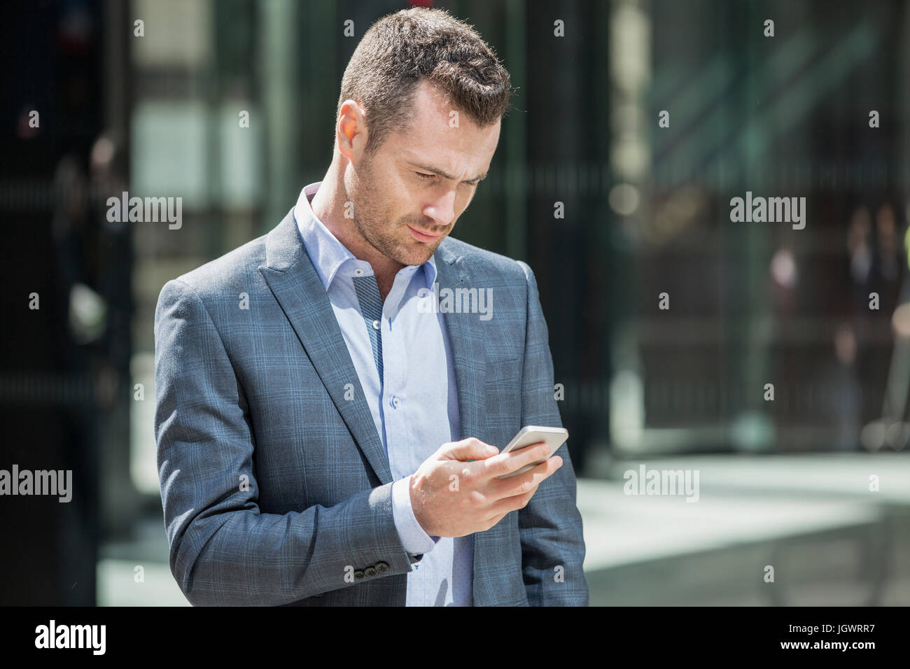 Businessman using mobile phone Stock Photo - Alamy