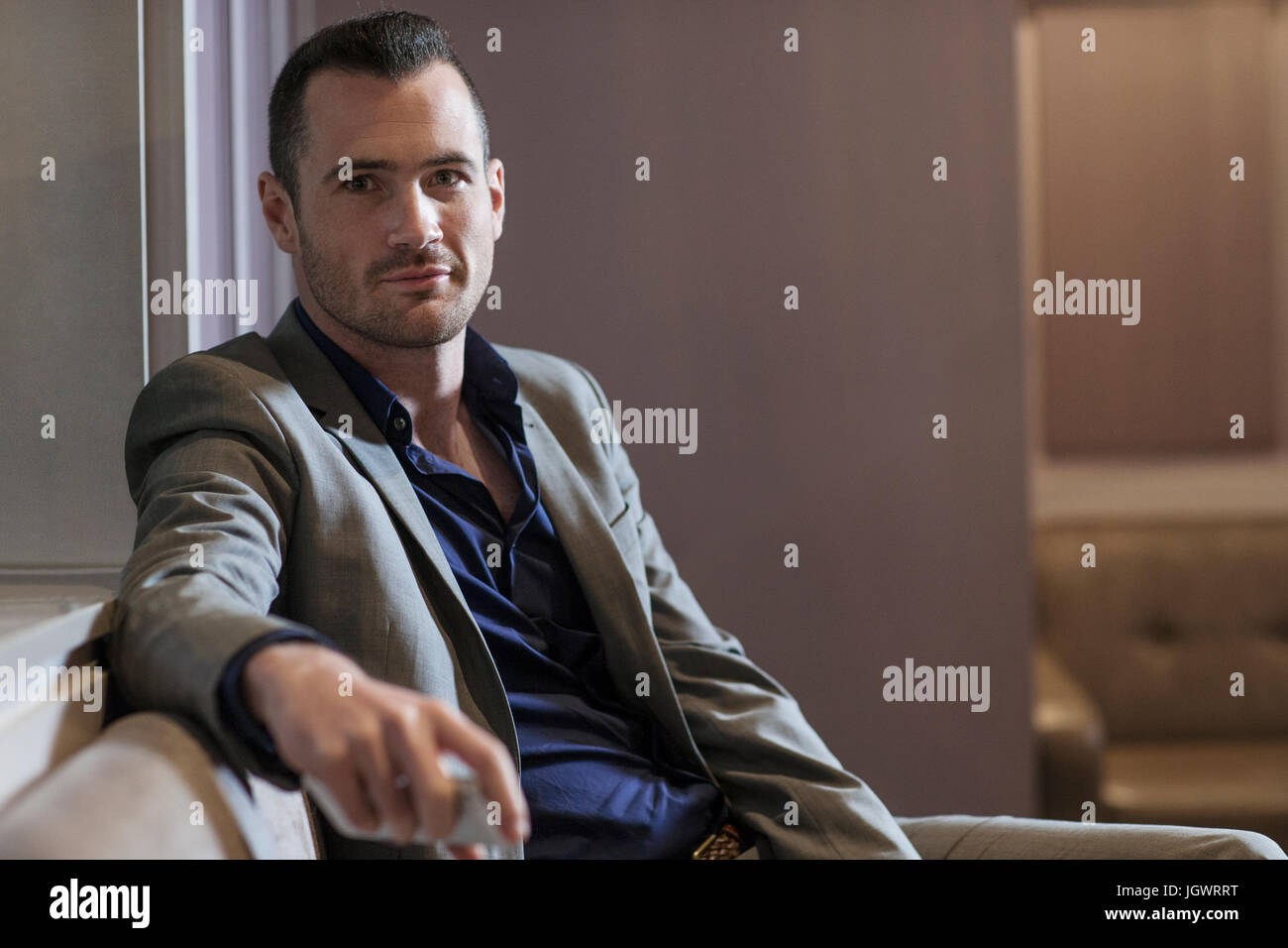 Businessman taking break on couch Stock Photo - Alamy