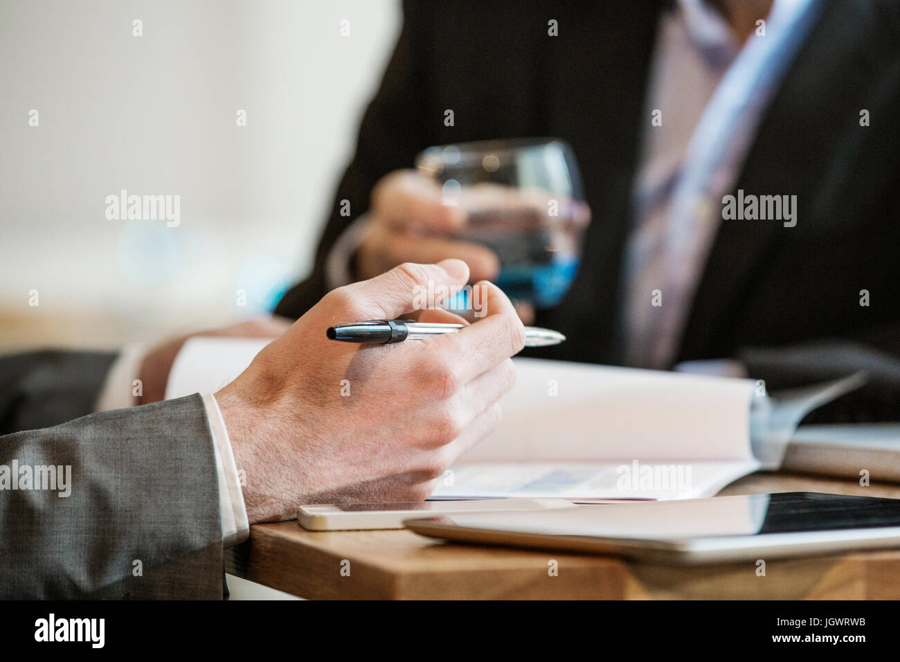 Businessmen working and making notes of discussion Stock Photo - Alamy