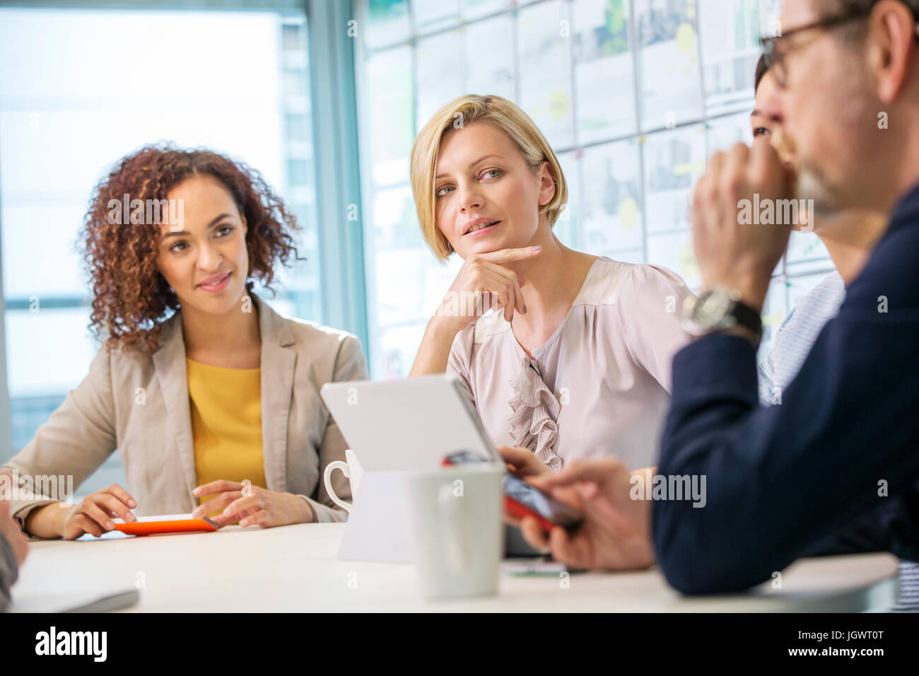 Digital design team discussing ideas at conference table Stock Photo ...
