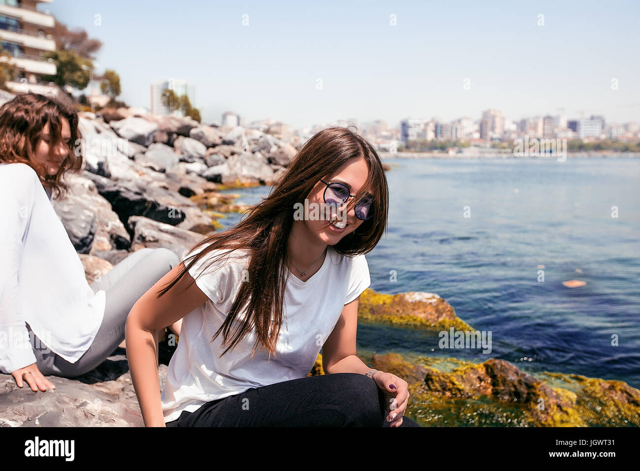 Best friends relaxing on rocks Stock Photo - Alamy