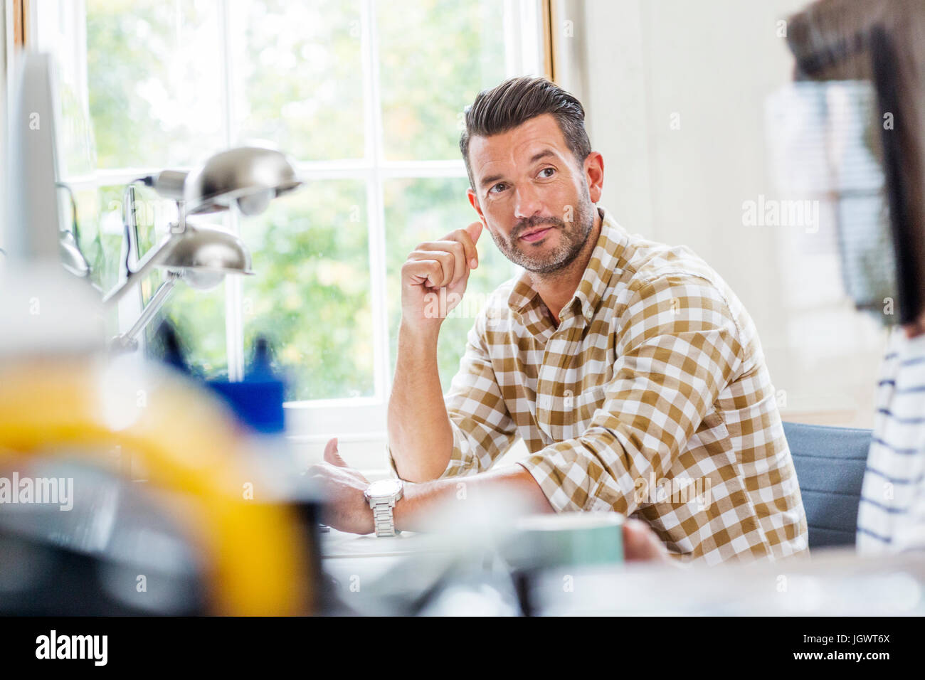 Male and female designers having meeting in creative studio Stock Photo ...