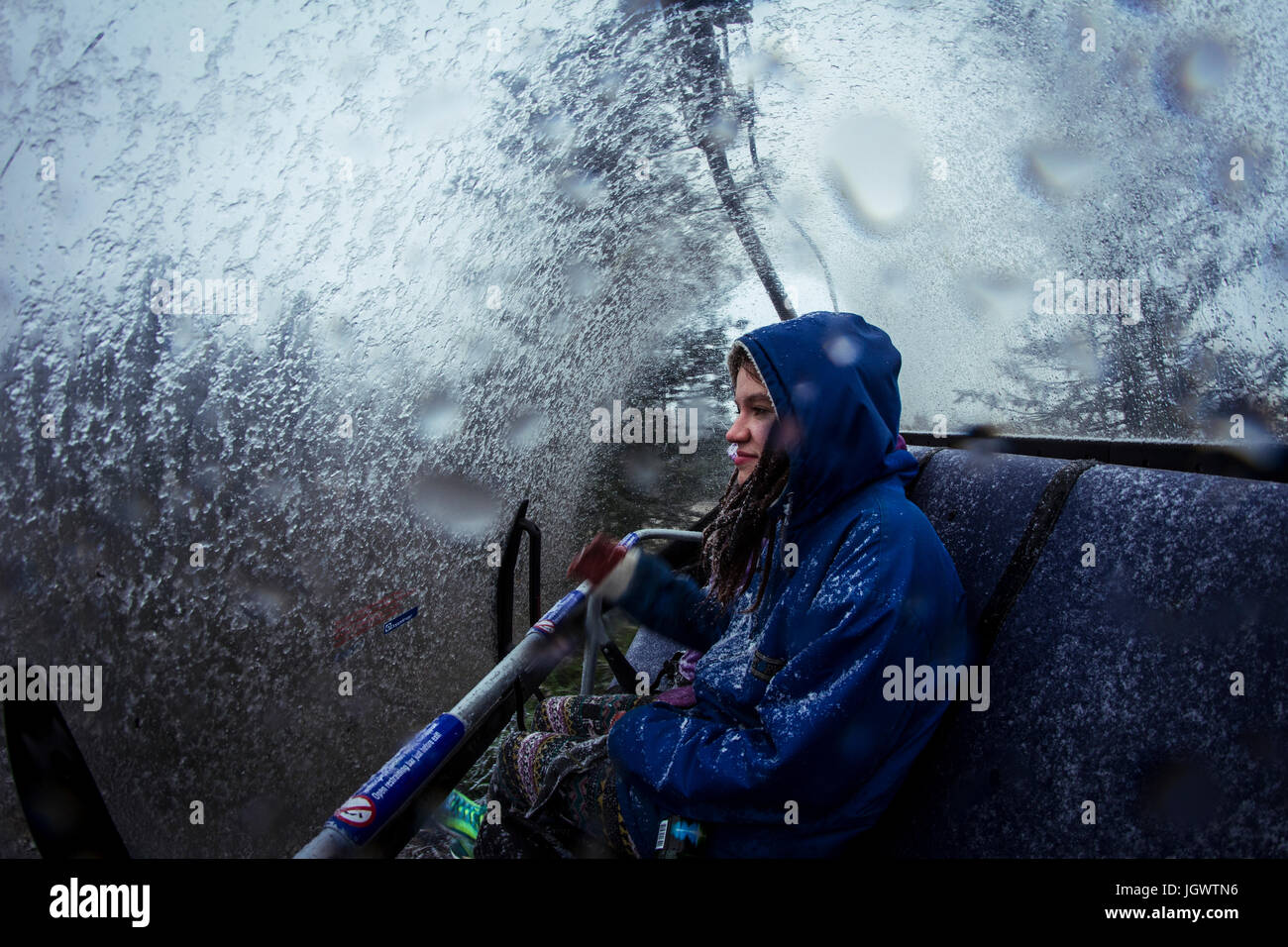 Young female hiker in chairlift during mountain snowstorm Stock Photo ...