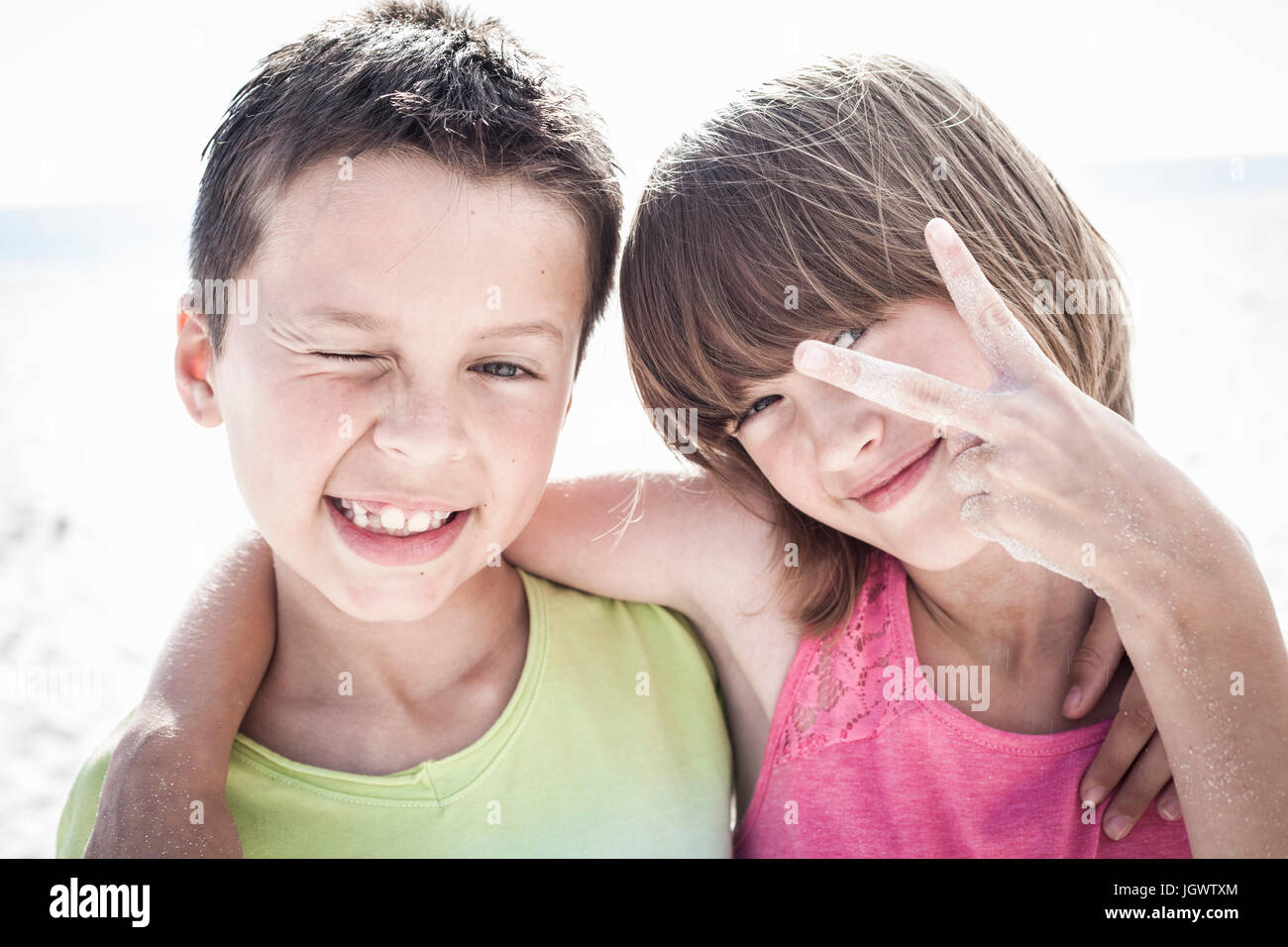 Brother with sister making peace sign Stock Photo - Alamy