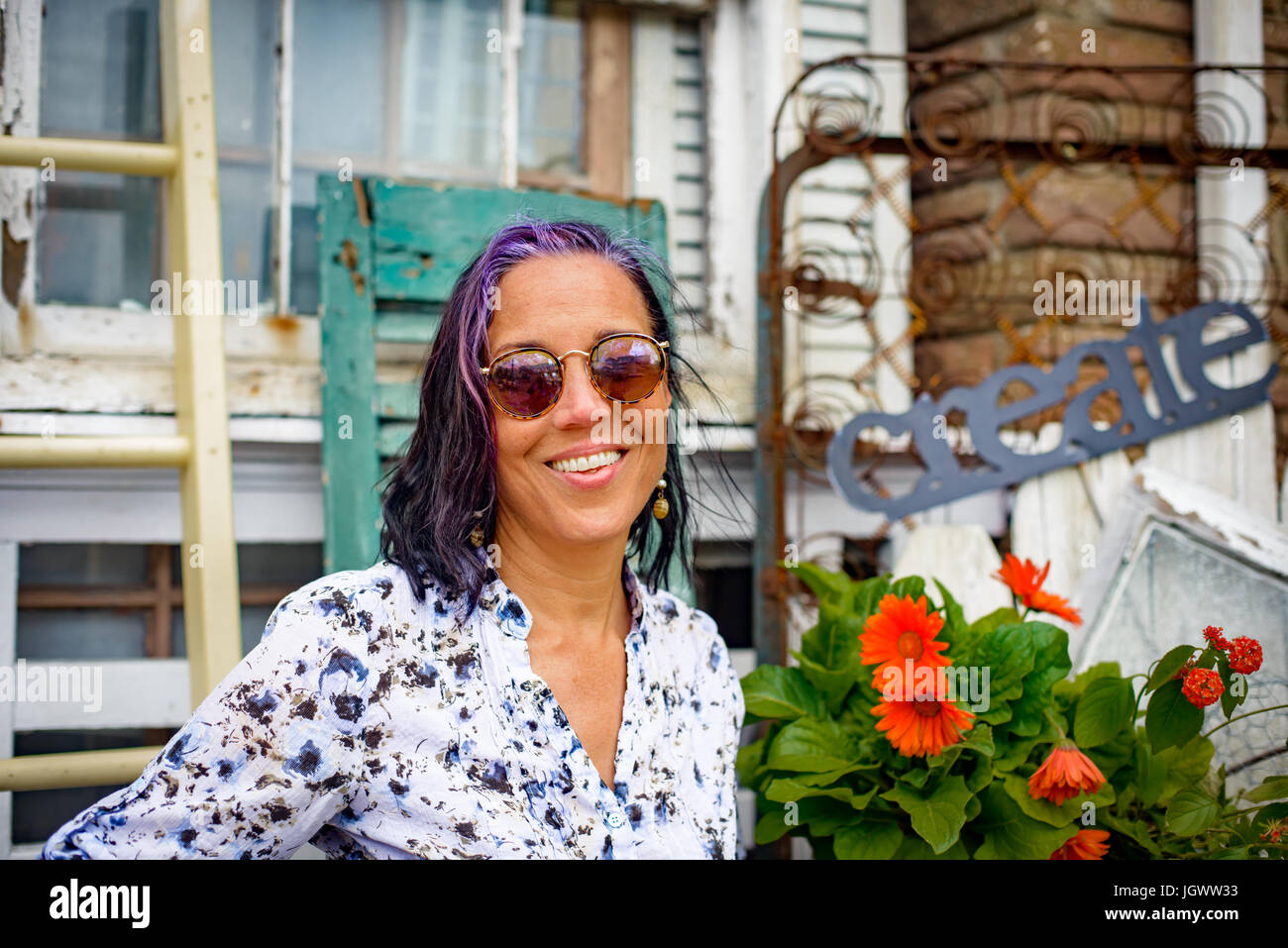 Portrait of female shop keeper outside front porch shabby chic shop ...