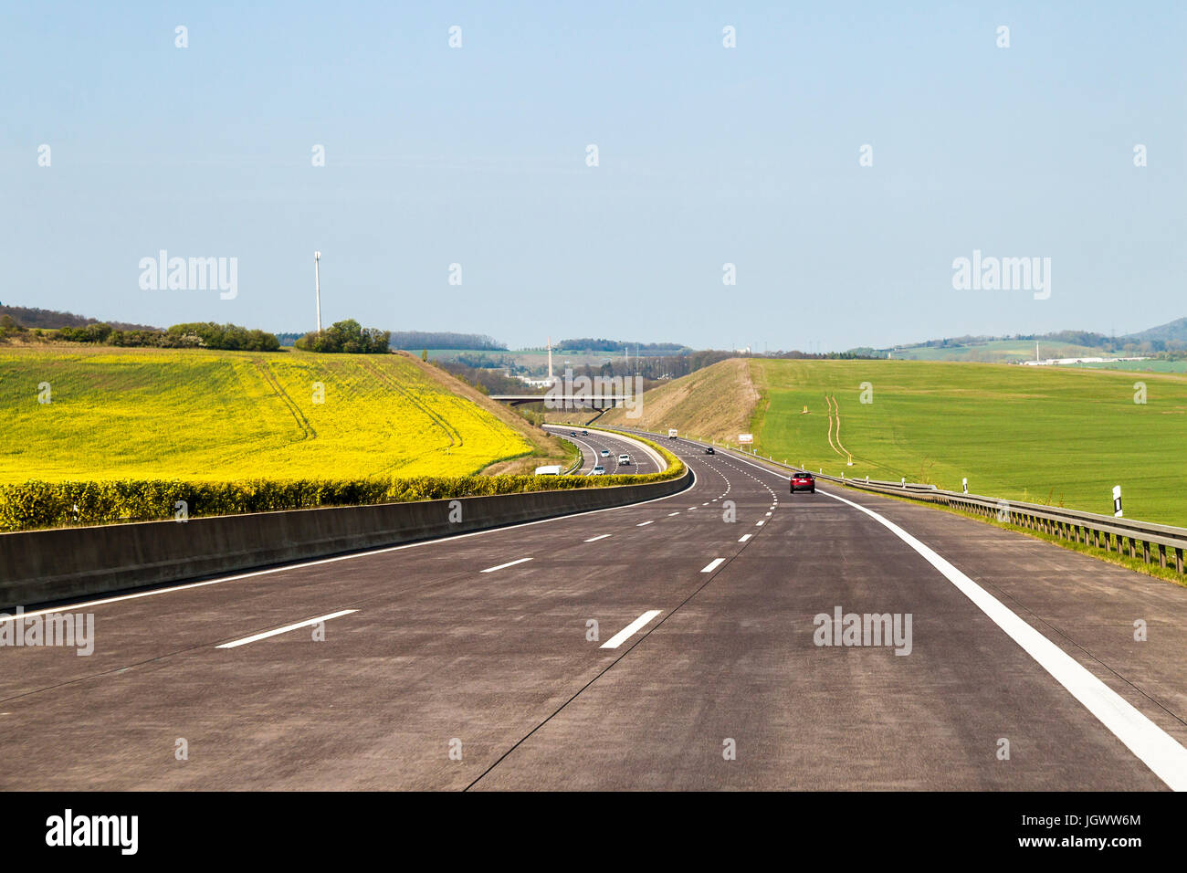 Brand new freeway road in Germany. Motorway between green fields in ...