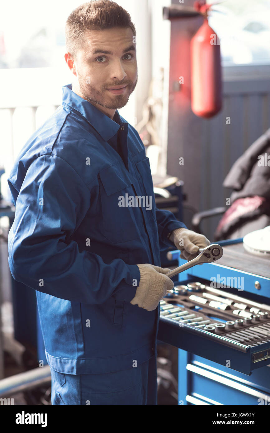 Mens kingdom. Good handsome qualified serviceman standing by the tool ...