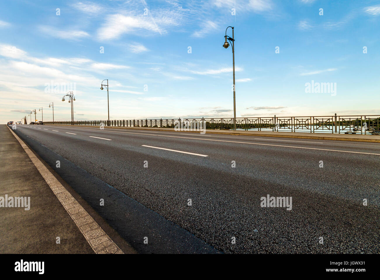 Empty asphalt road on a bridge over river Stock Photo - Alamy
