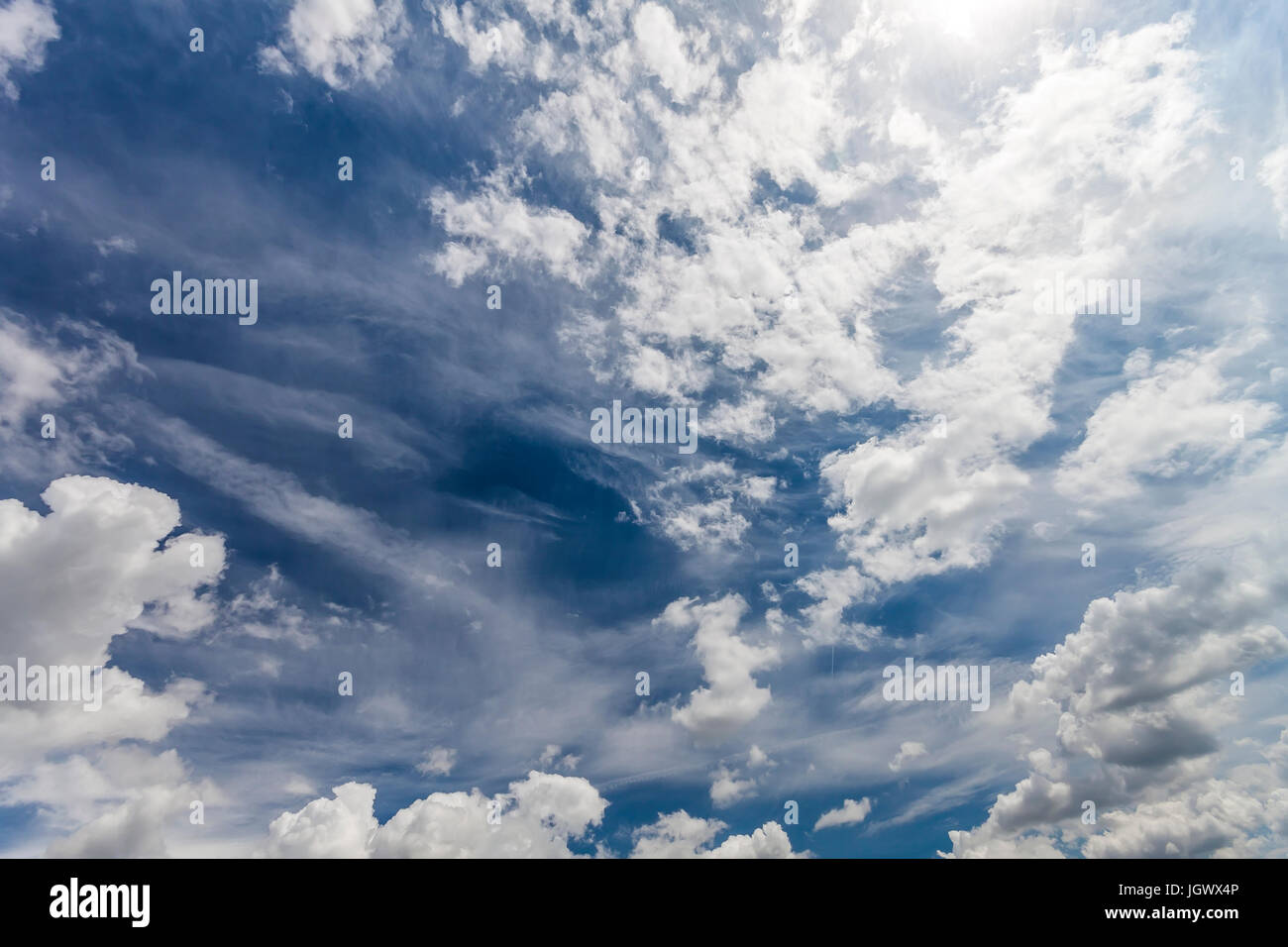 Dramatic blue sky with puffy white clouds in bright clear spring day ...