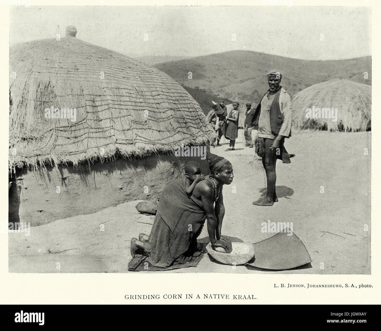 African woman grinding corn in a native kraal, 1913 Stock Photo - Alamy