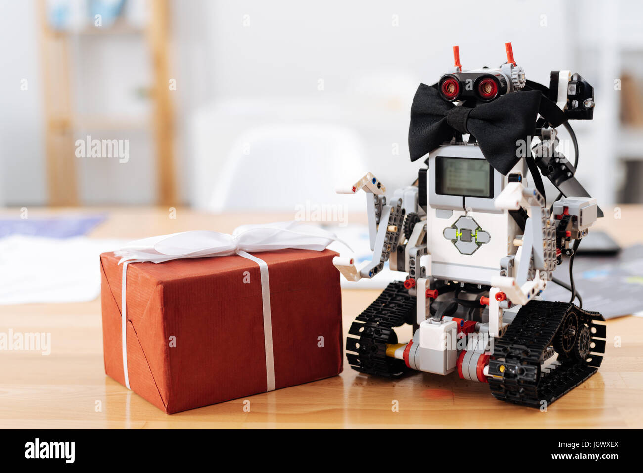 Here for you. Cute stylish romantic robot standing on the table and ...