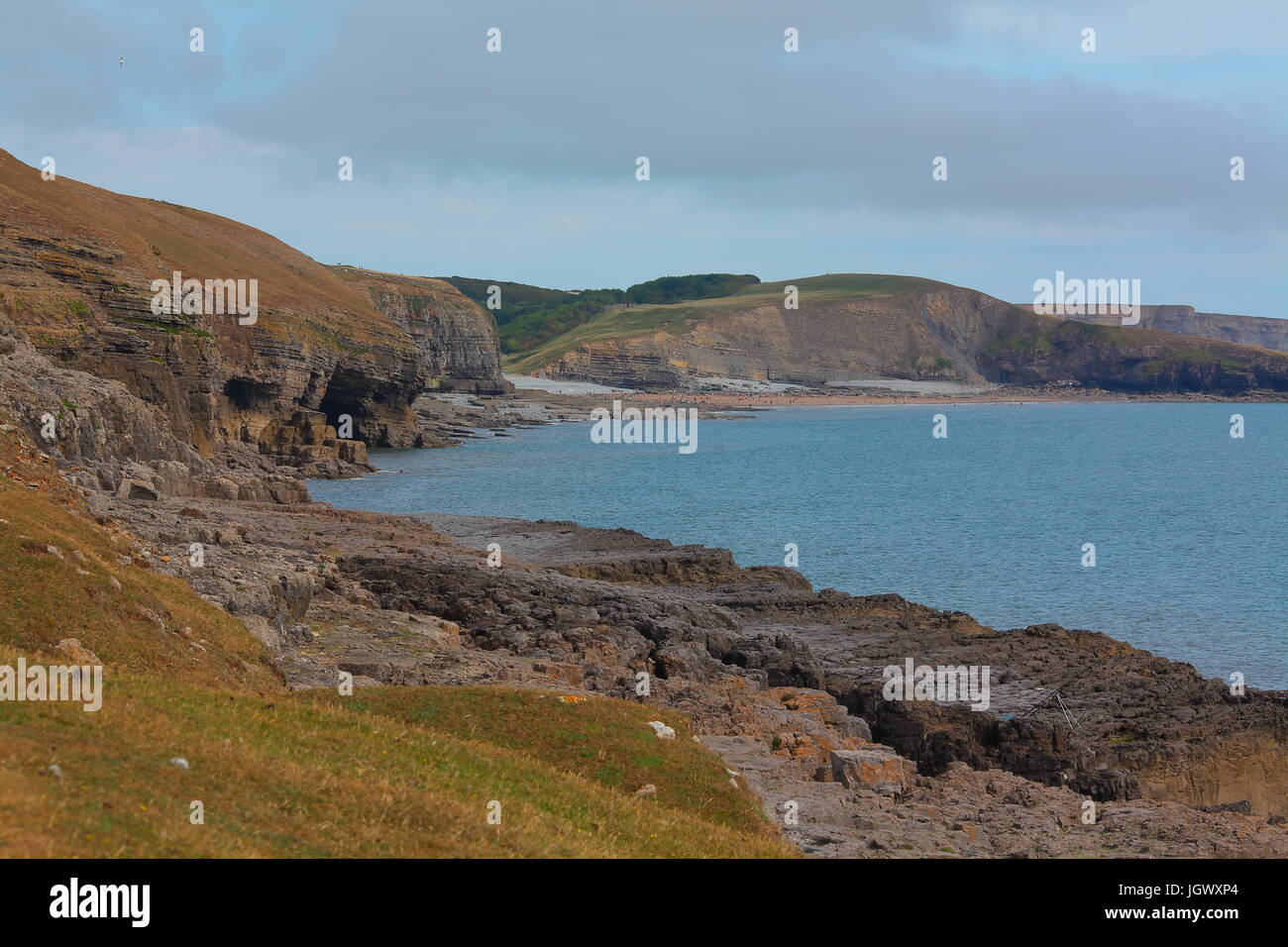 A distant beach with many bathers and sun seekers relaxing and playing ...