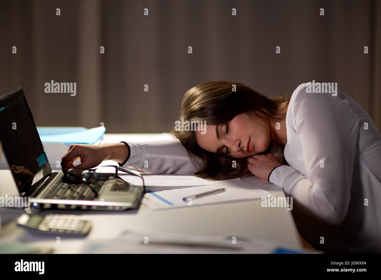 tired woman sleeping on office table at night Stock Photo - Alamy