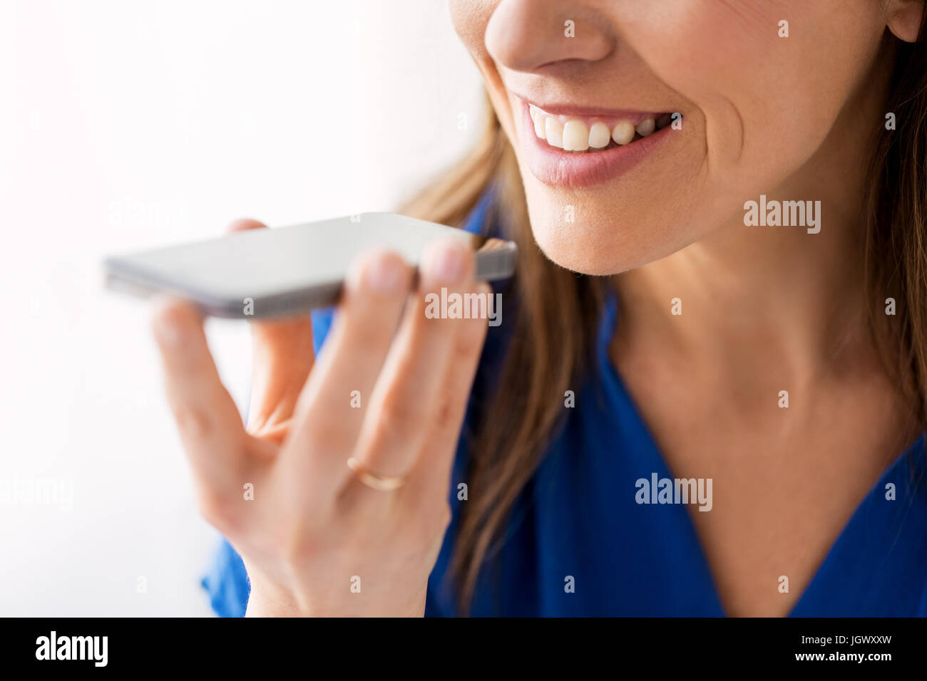 woman using voice recorder on smartphone Stock Photo - Alamy