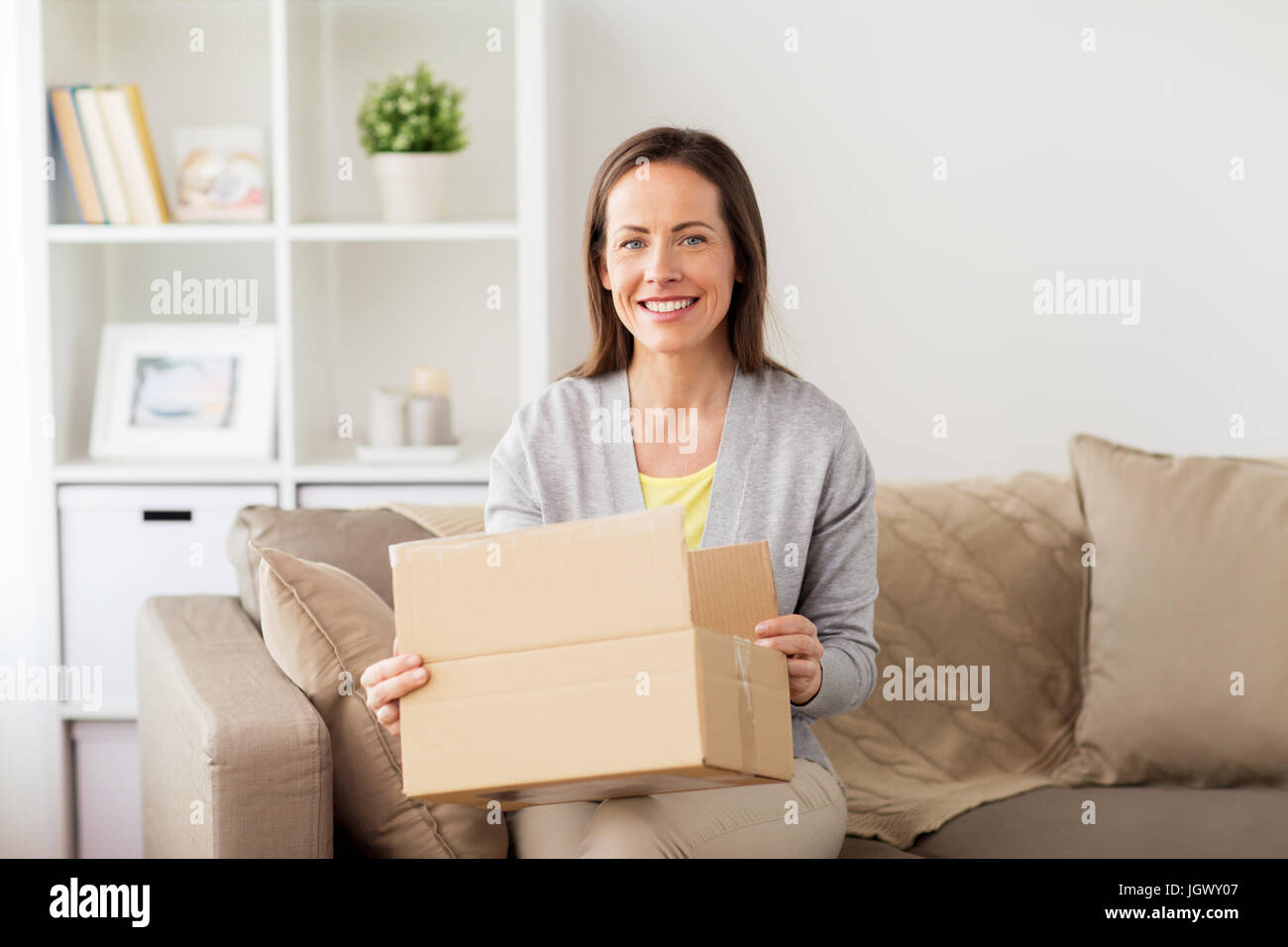 Woman opening cardboard box hi-res stock photography and images - Alamy