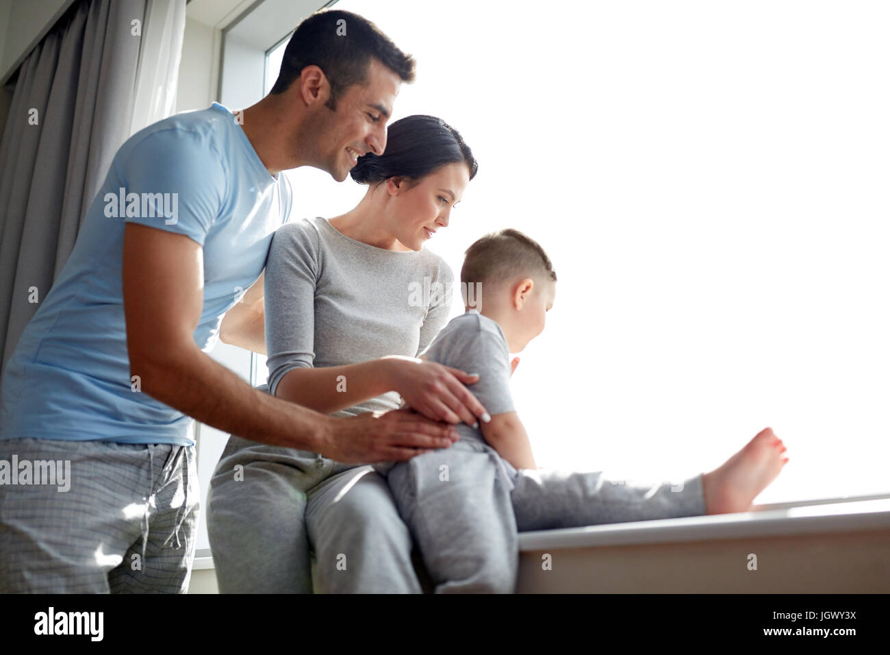happy family looking through window at home Stock Photo - Alamy