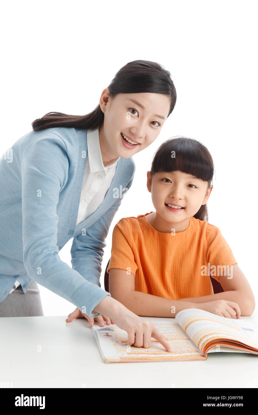 Female teacher helping school girl study Stock Photo - Alamy