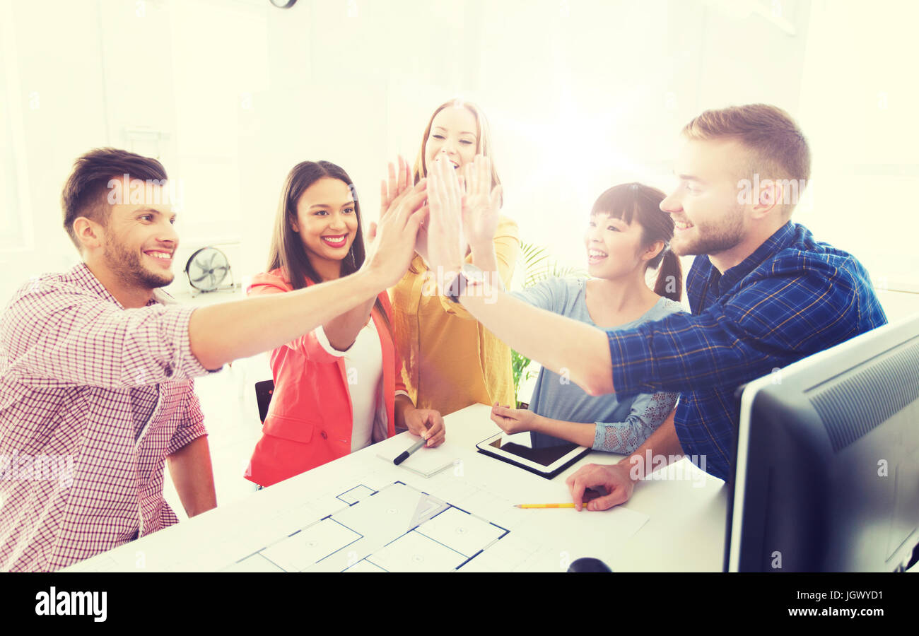 creative team making high five at office Stock Photo - Alamy