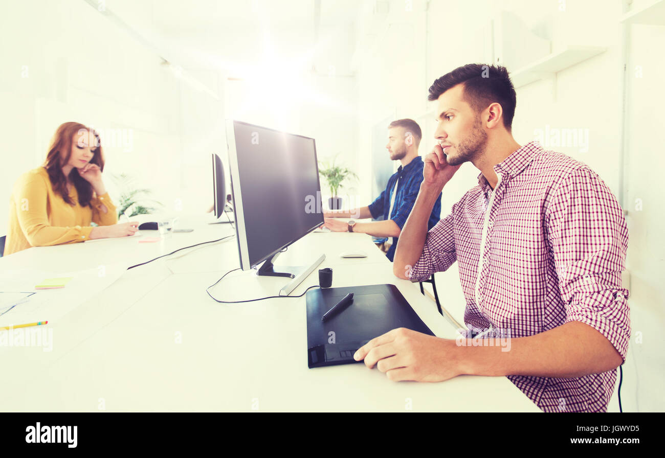 man or designer with computer and tablet at office Stock Photo - Alamy