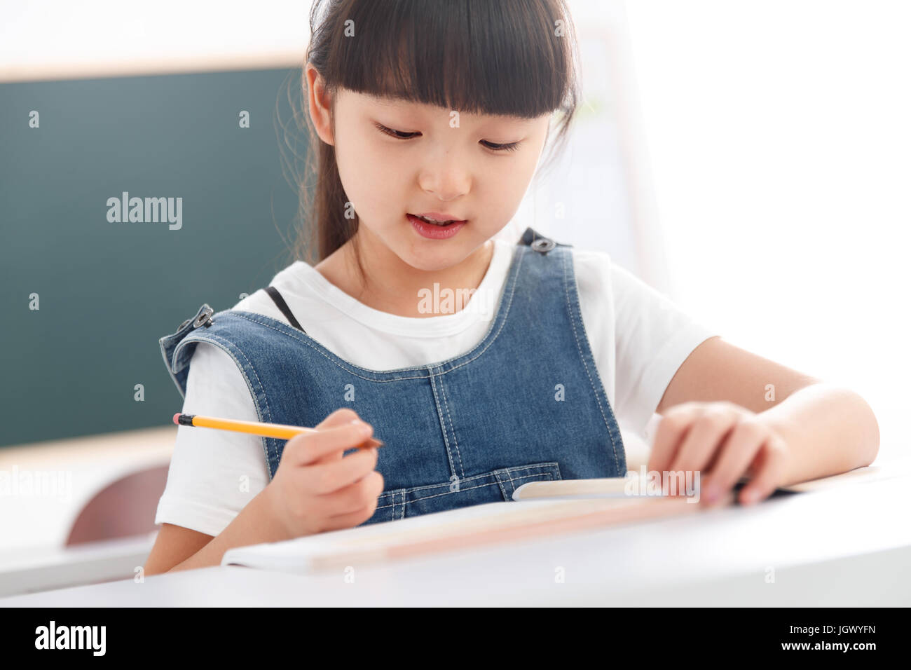 Primary school girls in the classroom Stock Photo - Alamy