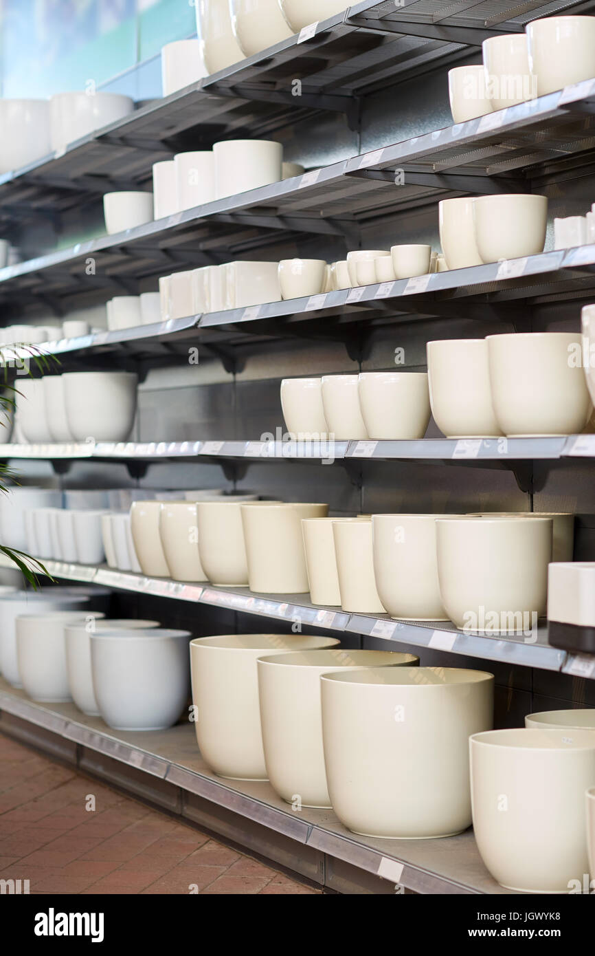 flower pots on shelves at garden shop Stock Photo - Alamy