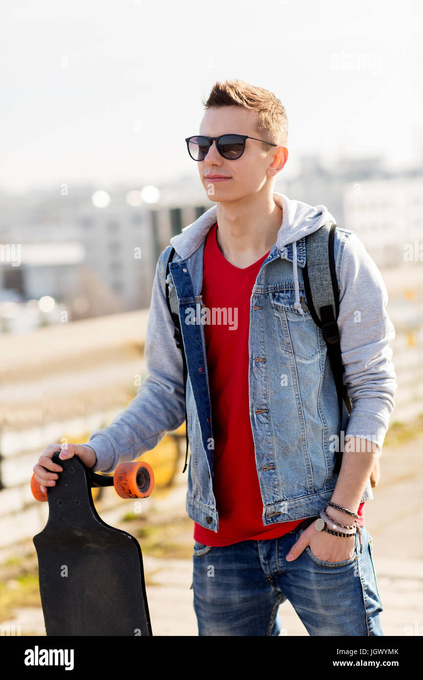 happy young man or teenage boy with longboard Stock Photo - Alamy