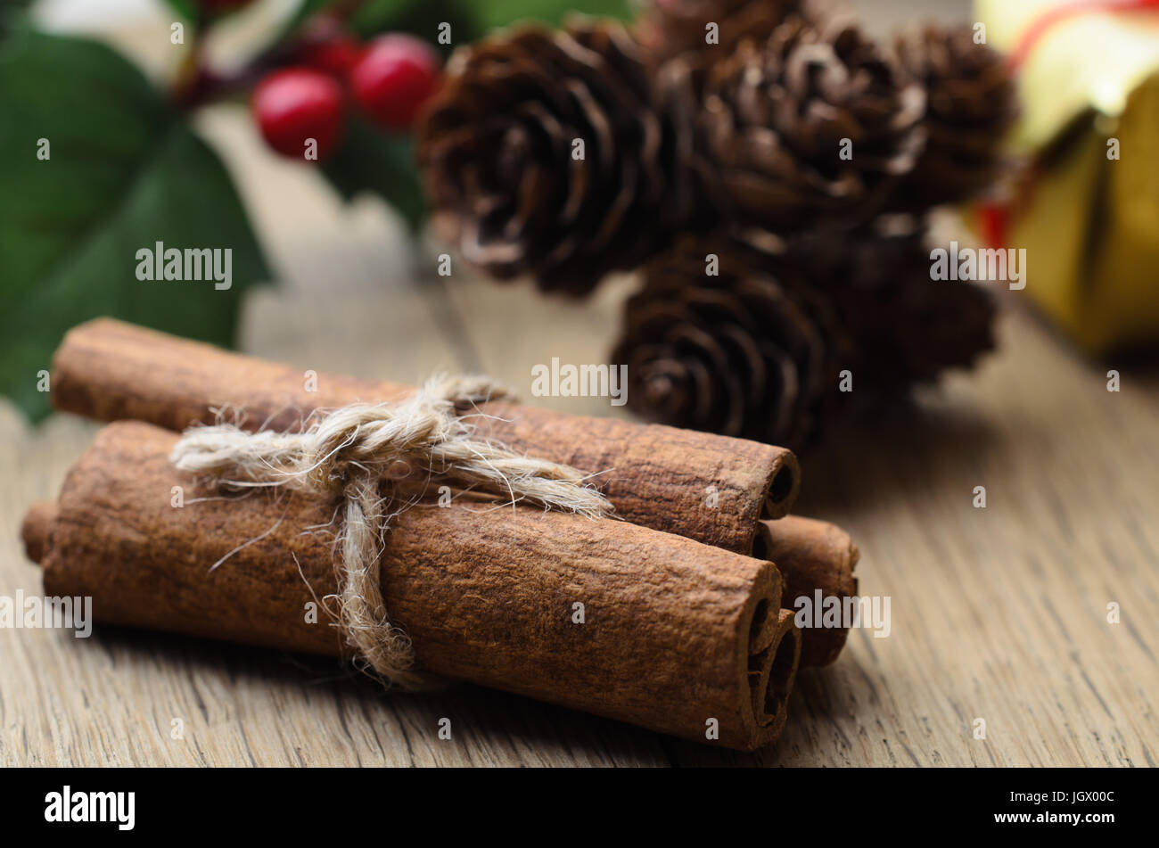 Cinnamon sticks, tied in a bundle with string on an oak table with ...